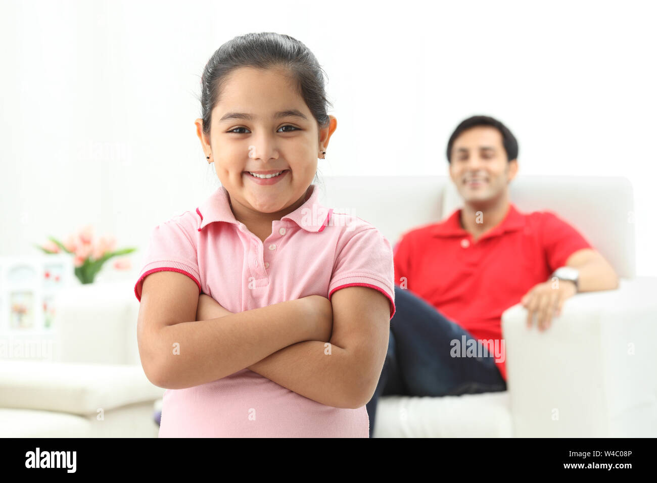 Portrait of a girl smiling with her father in the background Stock ...