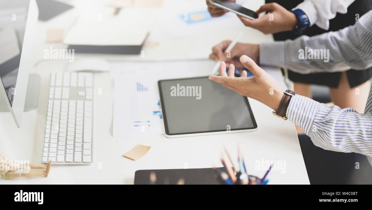 UI UX website development team sketching wireframe layout for responsive web content in studio ...
