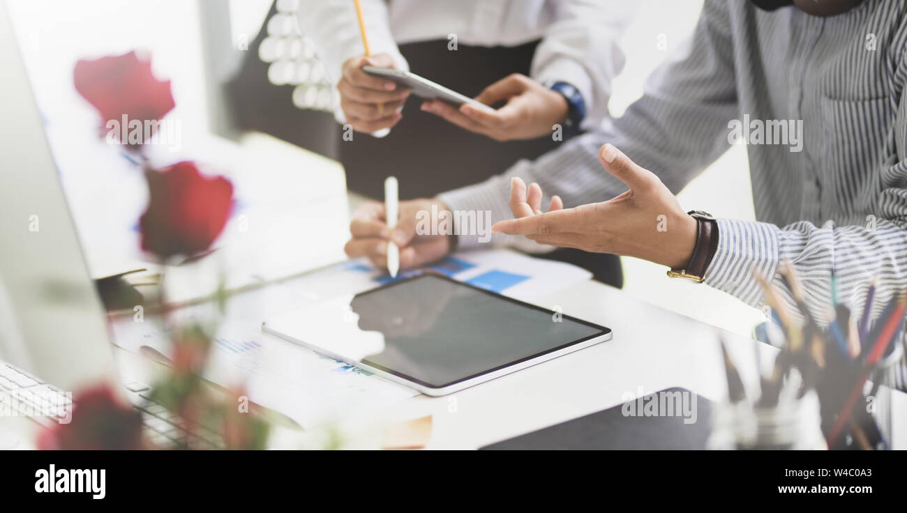 UI UX website development team sketching wireframe layout for responsive web content in studio ...