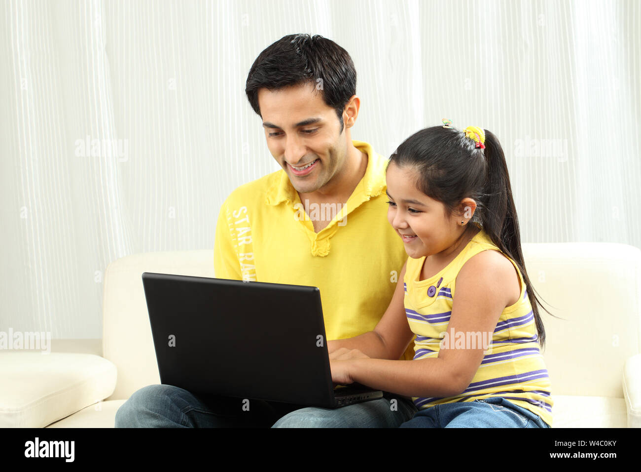 Smiling black girl using a laptop hi-res stock photography and images - Alamy
