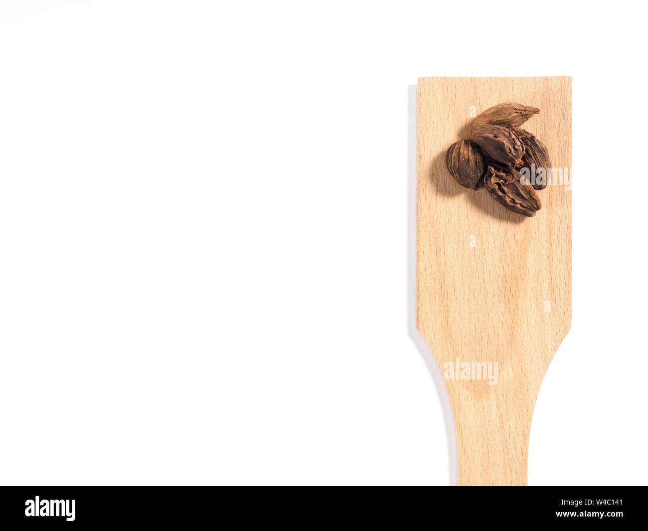 Black cardamom (Amomum subulatum) on spoon on a white background Stock ...