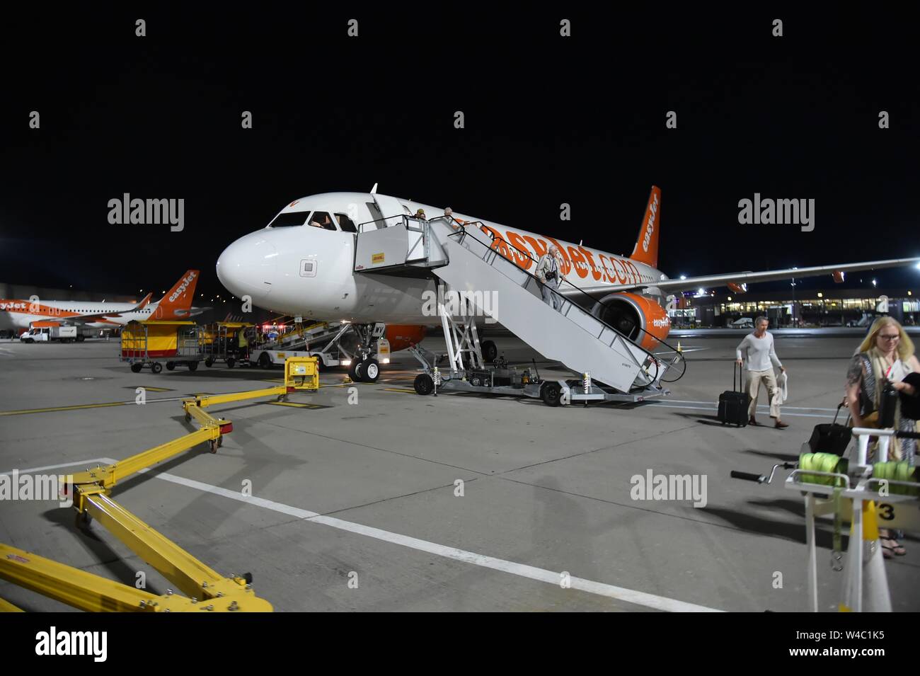 EasyJet aeroplane at the terminal at night Stock Photo - Alamy