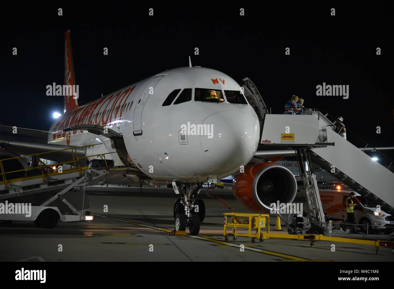 EasyJet aeroplane at the terminal at night Stock Photo - Alamy
