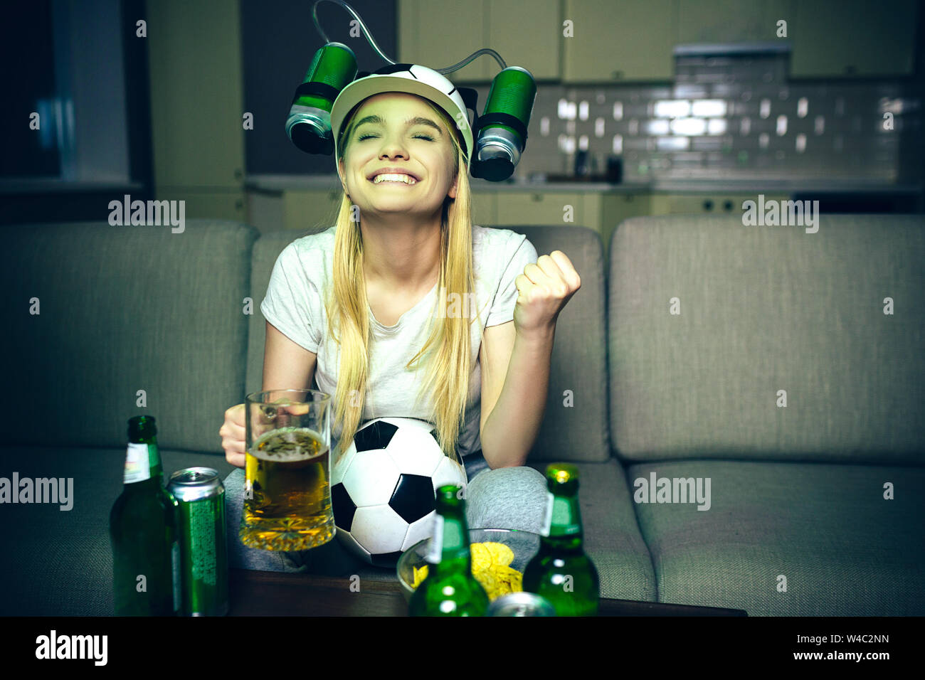 Young woman watch football game on tv at night. Cheerful positive model ...