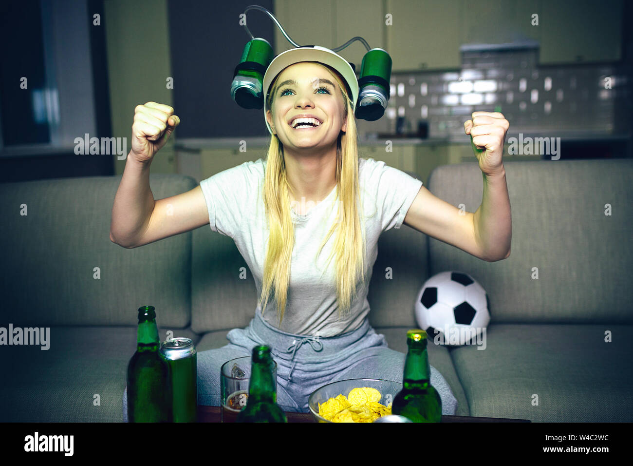Young woman watch football game on tv at night. Cheerful positive model ...