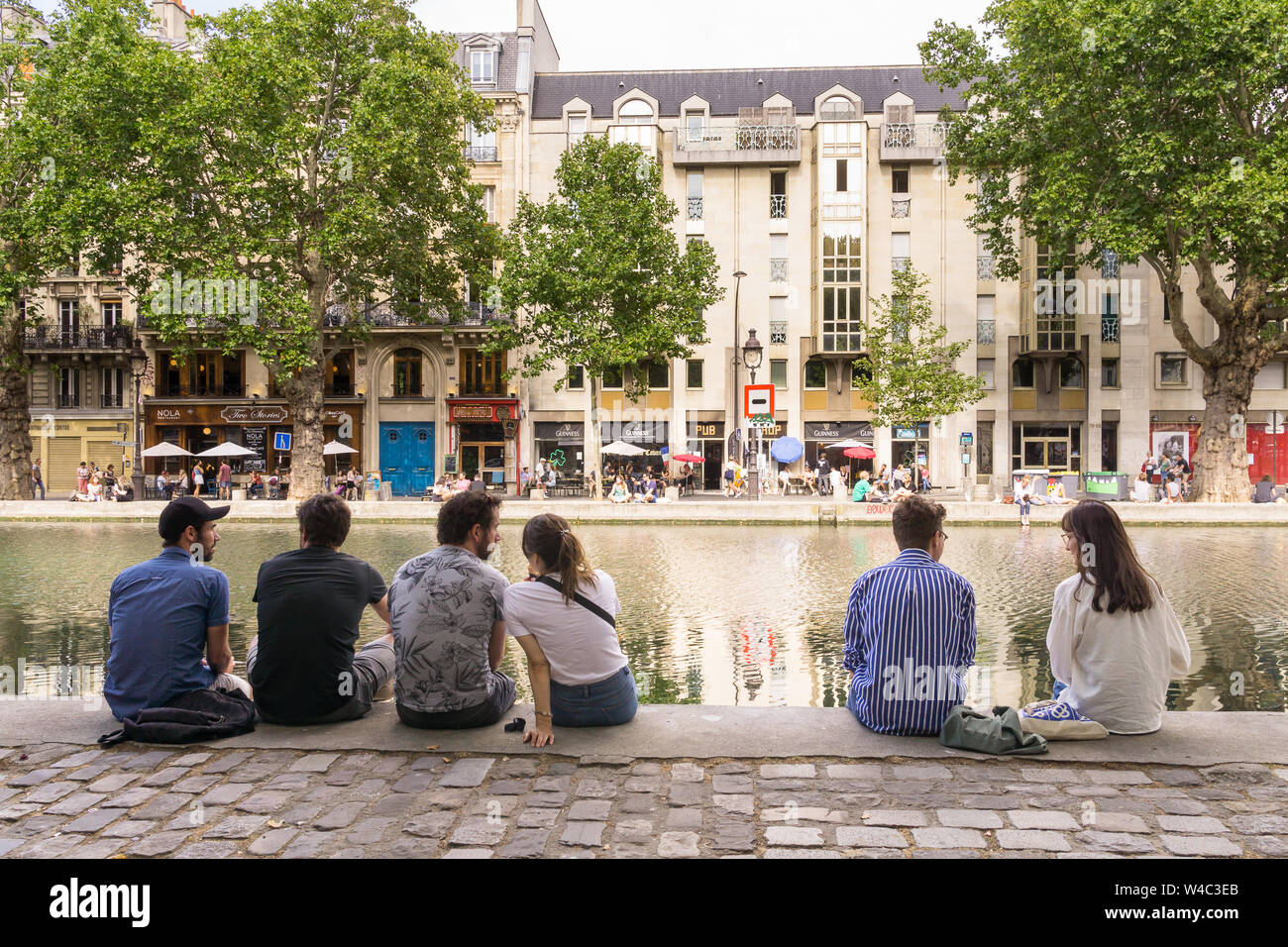 Paris Canal Saint Martin - People sitting along the Canal Saint Martin ...