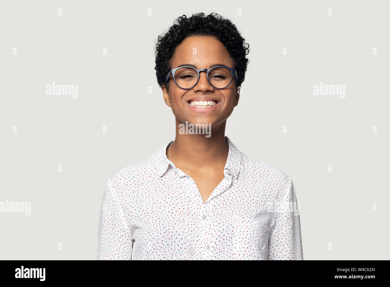 Portrait of smiling ethnic woman posing on studio background Stock ...
