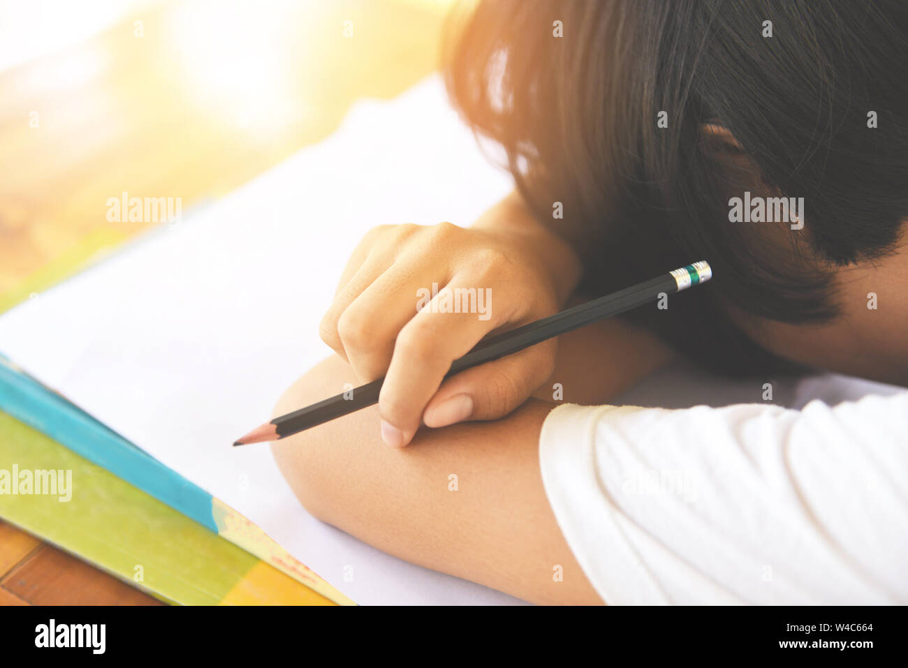 exam stress / education young female college in class taking notes and ...