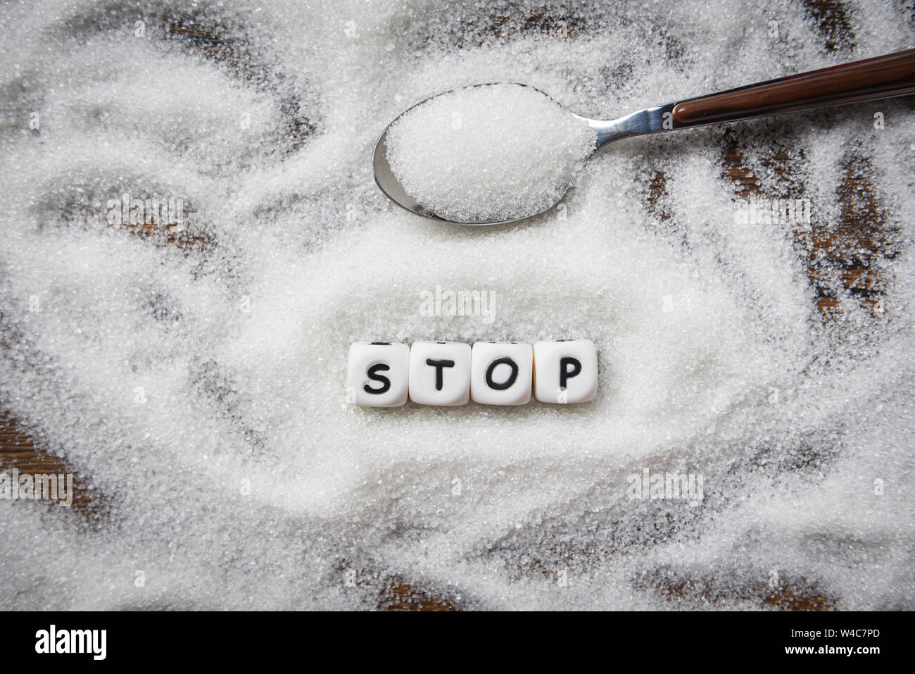 no sugar stop text blocks with white sugar on spoon wooden background ...