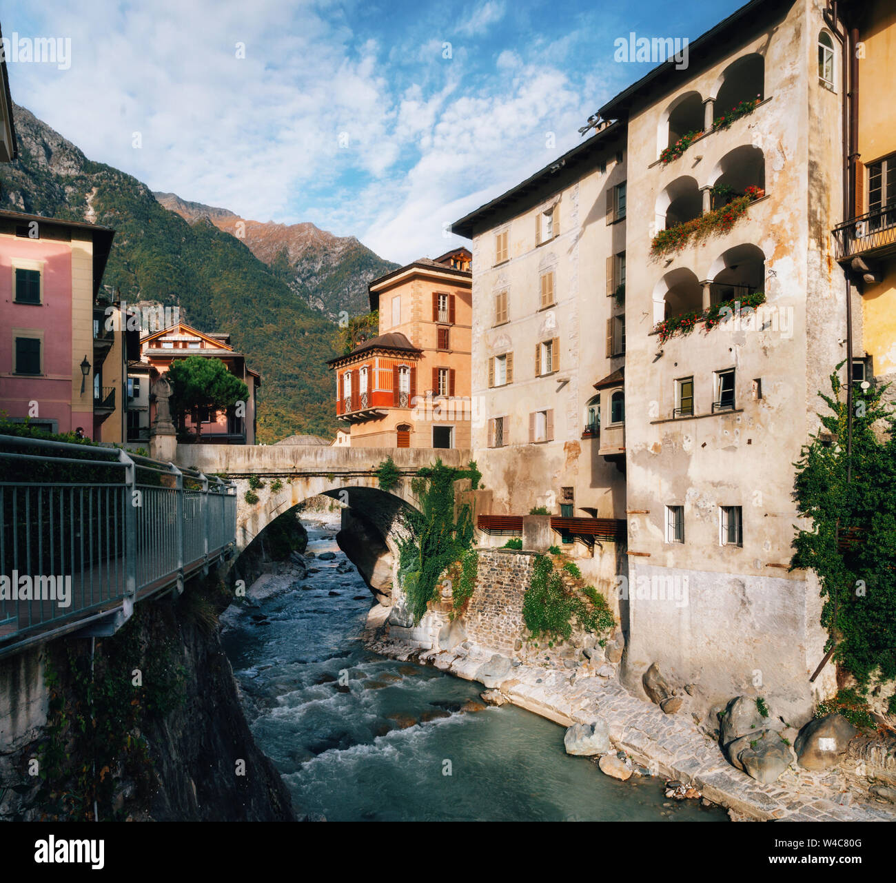 Scenic view on small river flowing through gorge between houses in cute ...