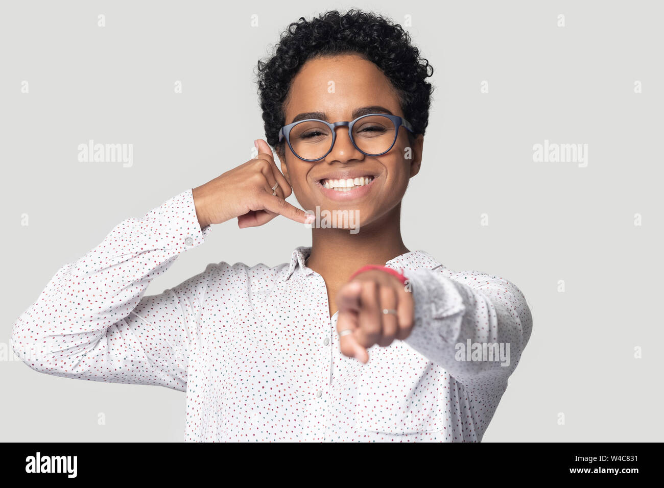 Smiling black woman point at camera ask call back Stock Photo - Alamy