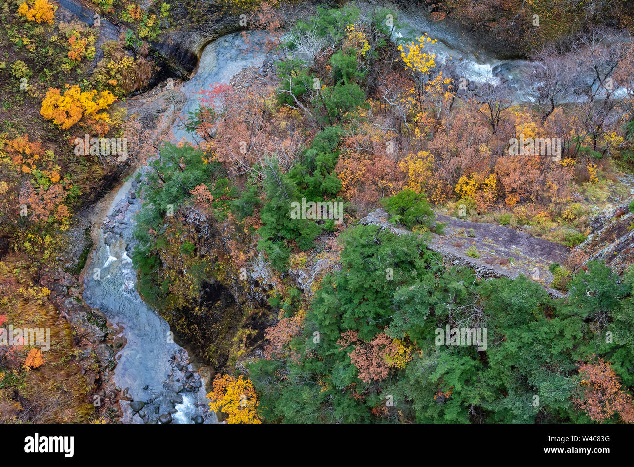 Autumn foliage scenery. Aerial view of valley and stream in fall season ...