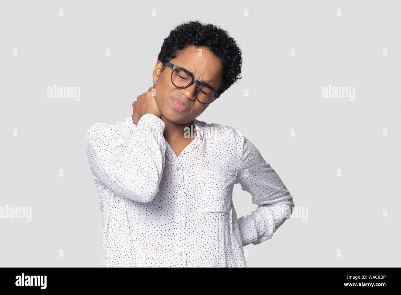 Unwell biracial girl stretching suffering from body spasm Stock Photo ...