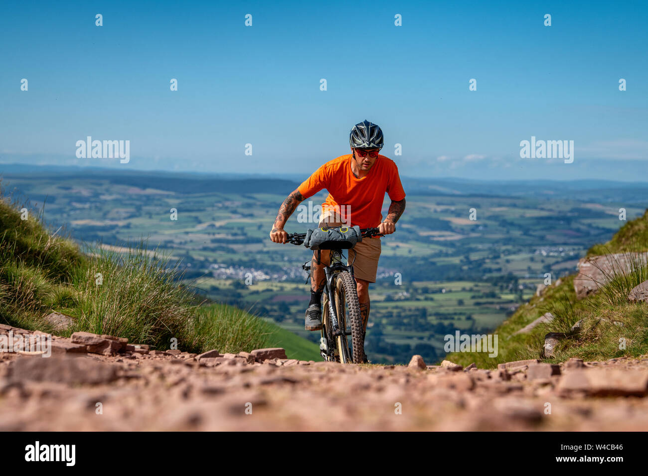 A man rides a mountain bike on the Sarn Helen Roman Road through the ...