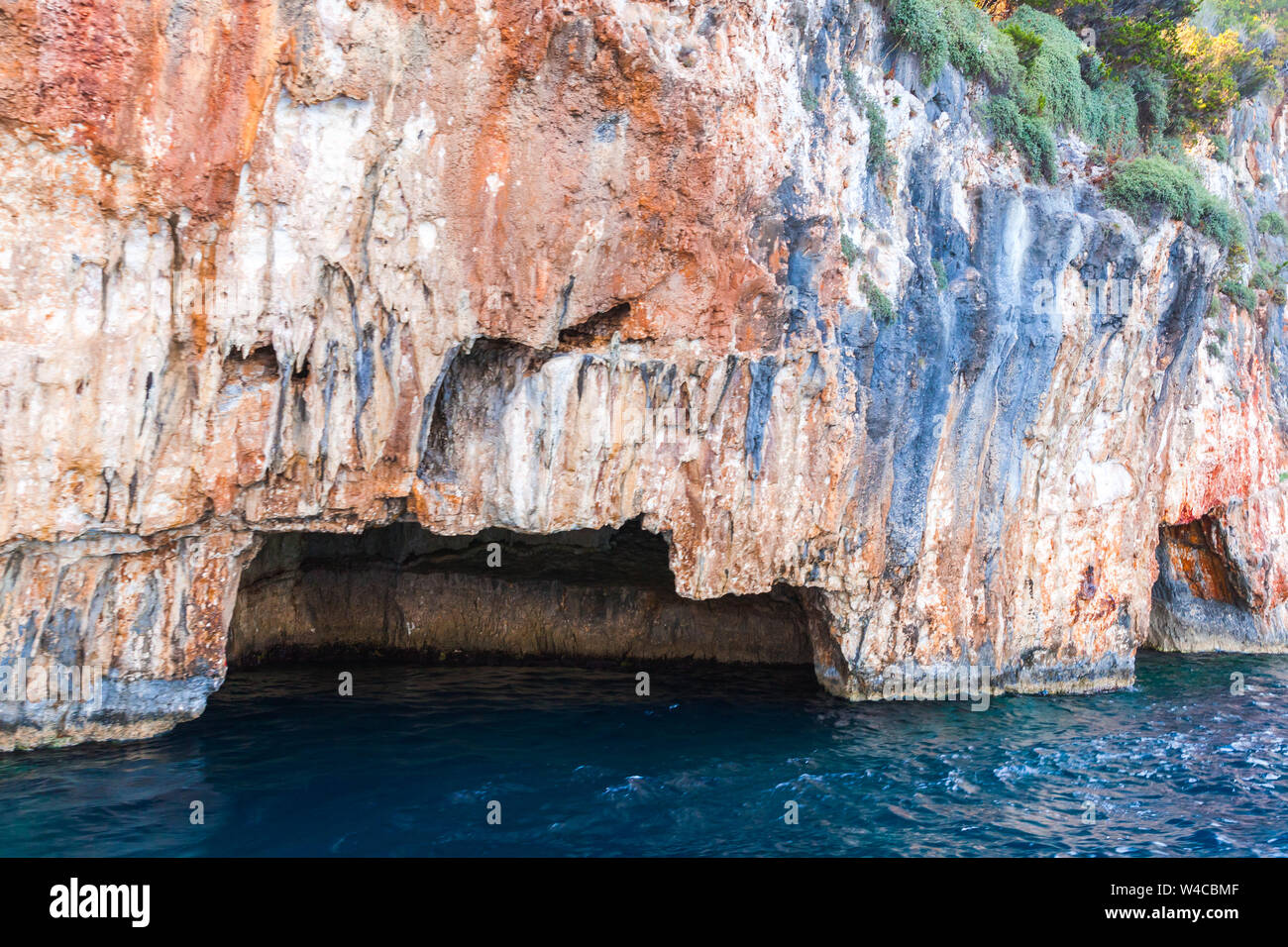 Coastal rocks of Greek island Zakynthos with caves and stone arches ...