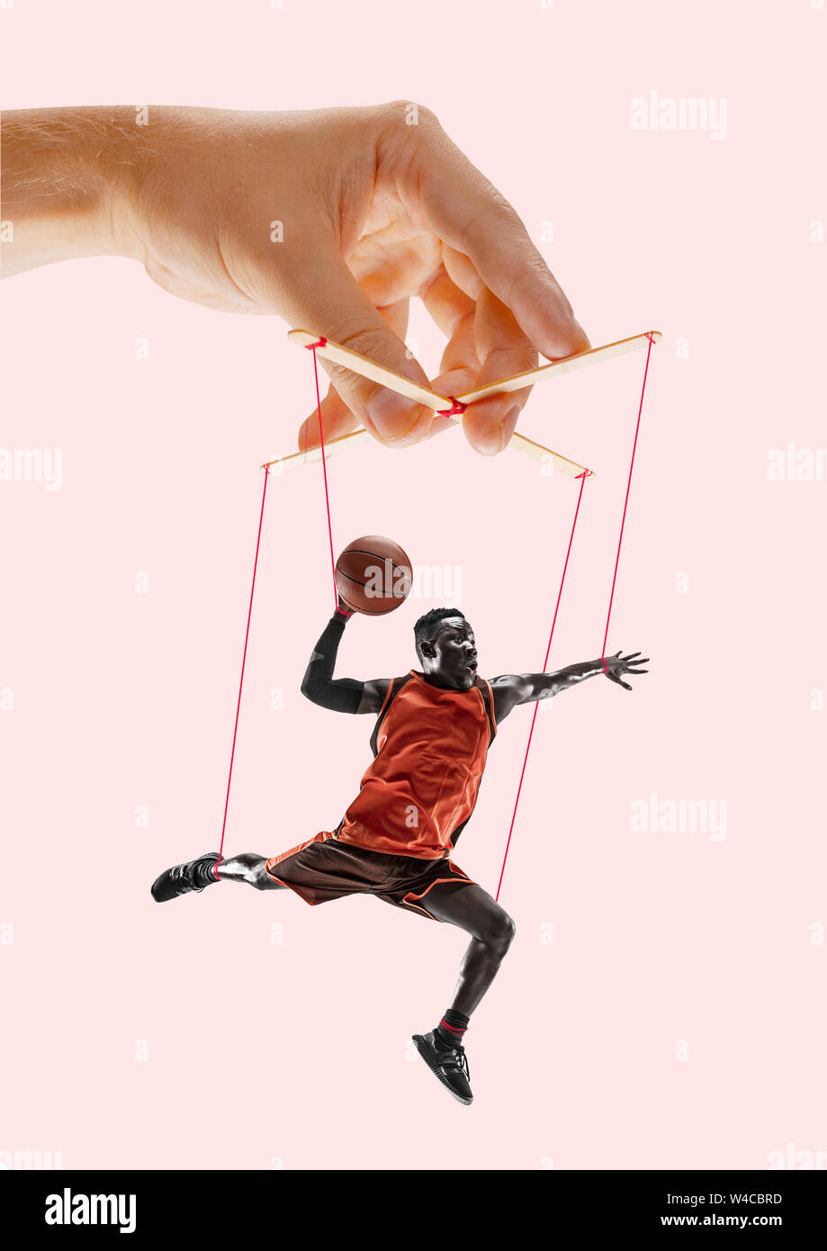 Man like a puppet in somebodies hands on coral background. Concept of ...