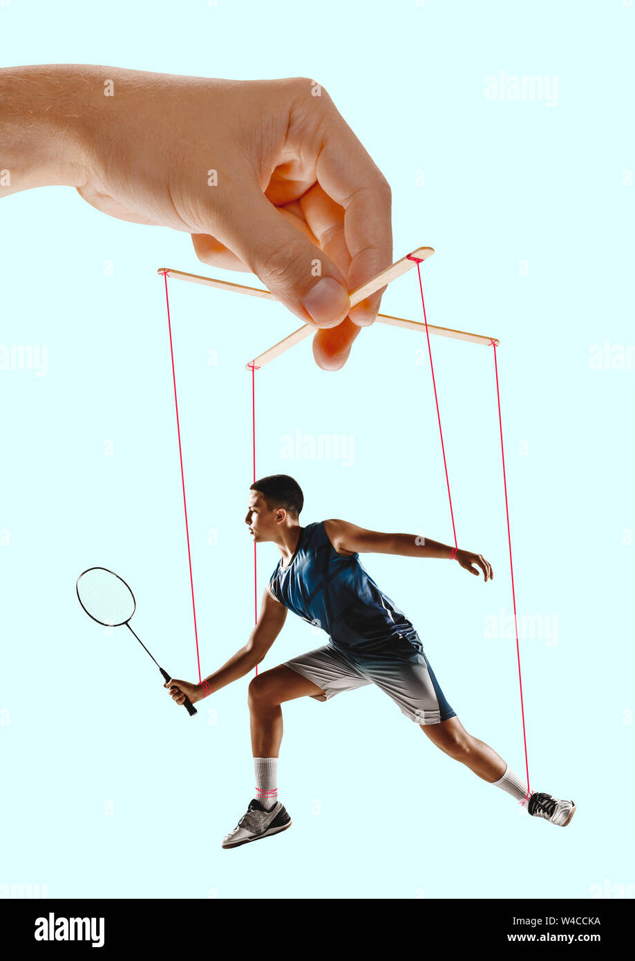 Boy like a puppet in somebodies hands on blue background. Concept of ...