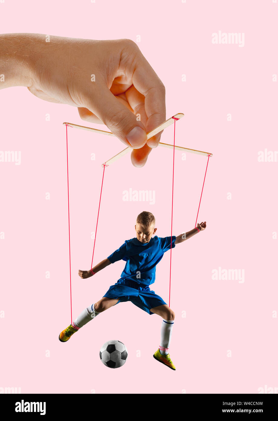 Boy like a puppet in somebodies hands on coral background. Concept of ...