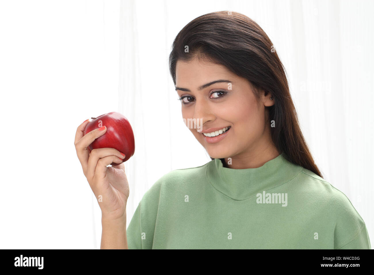 Portrait of a woman holding an apple Stock Photo - Alamy