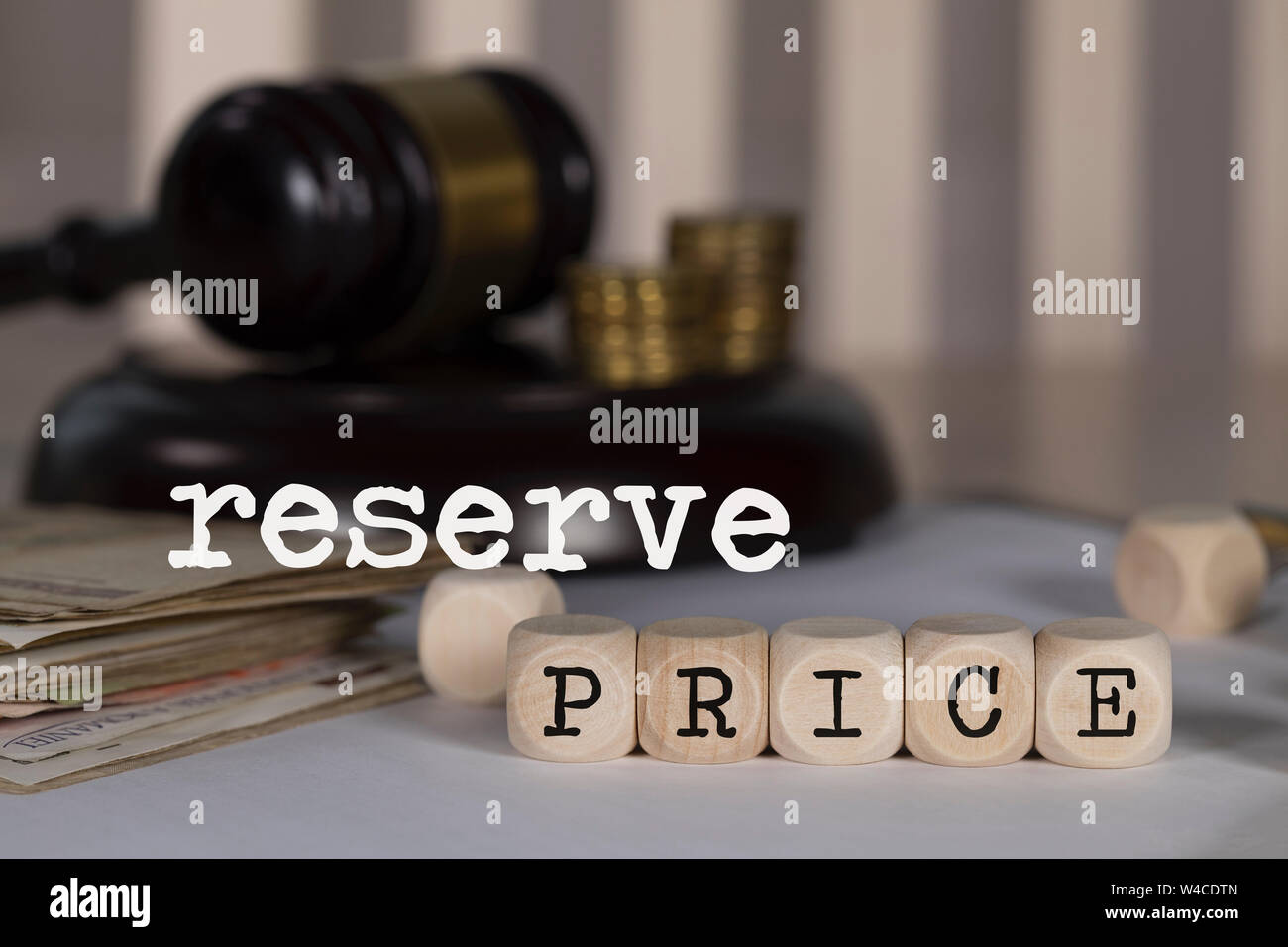 Words RESERVE PRICE composed of wooden dices. Auction gavel on the ...