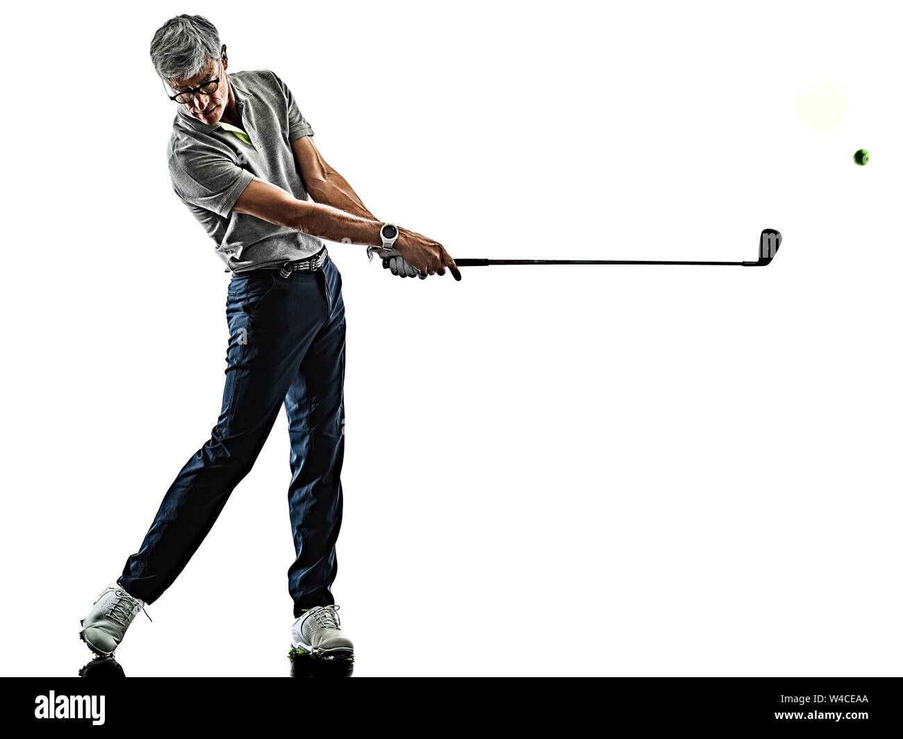 one caucasian senior man golfer golfing in studio shadow silhouette ...