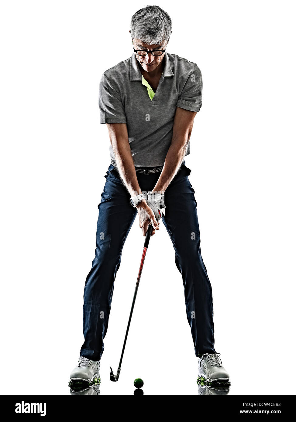 one caucasian senior man golfer golfing in studio shadow silhouette ...