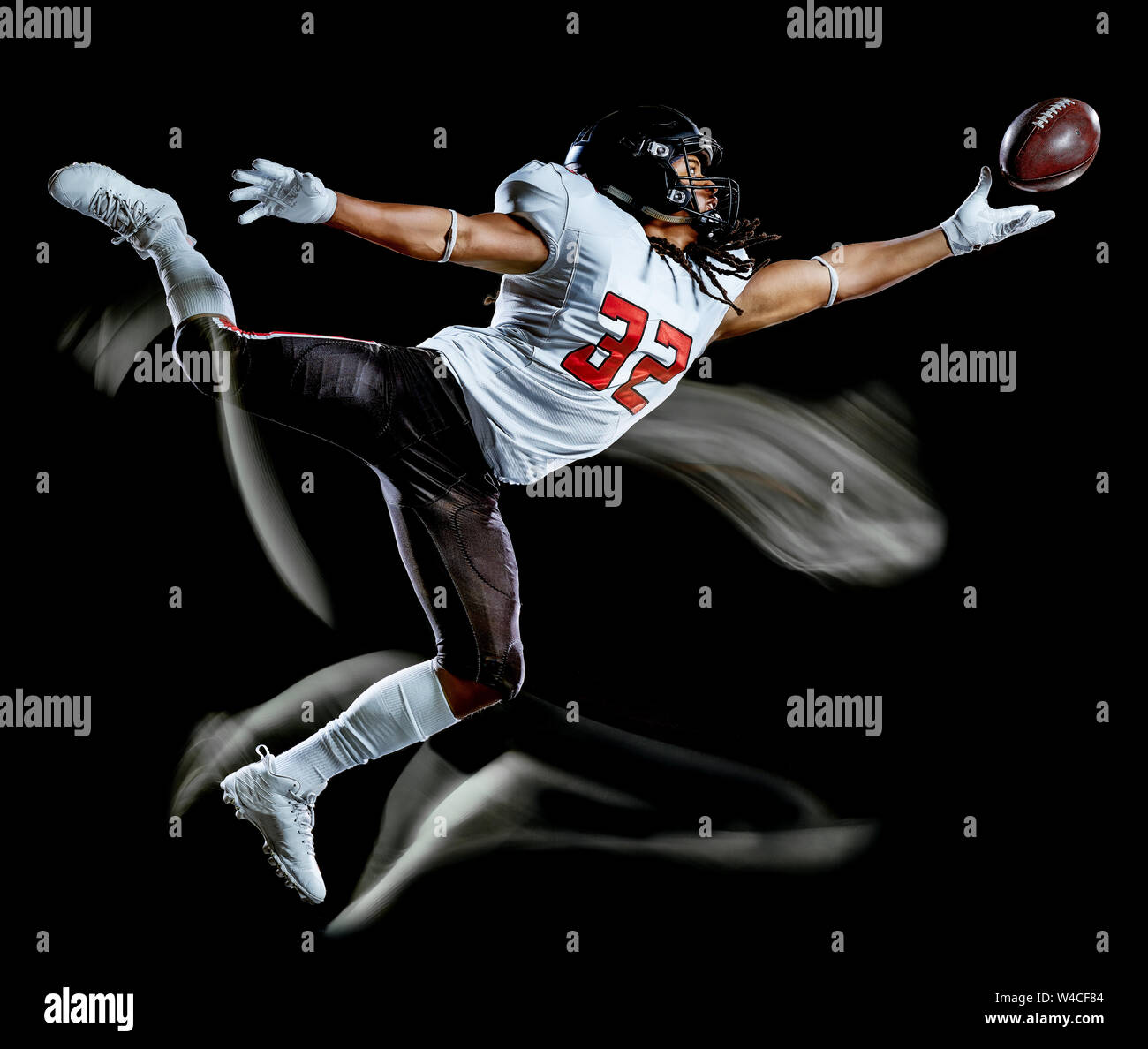 one african american football player man studio shot isolated on black ...