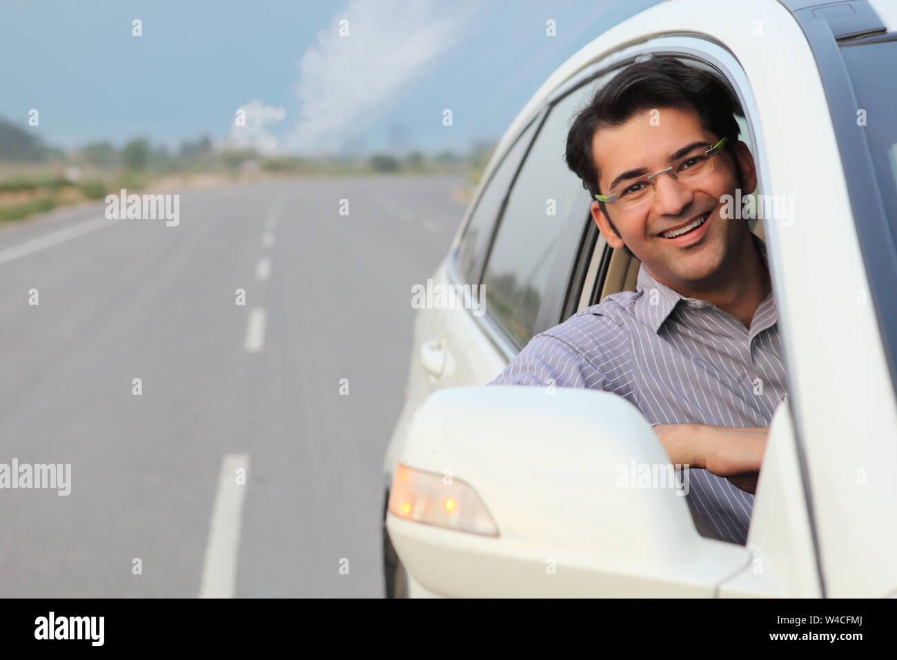 Sitting car transportation looking at camera smiling looking through ...