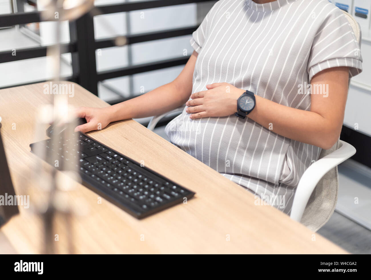 pregnant woman is working on computer laptop and mobile phone, business ...