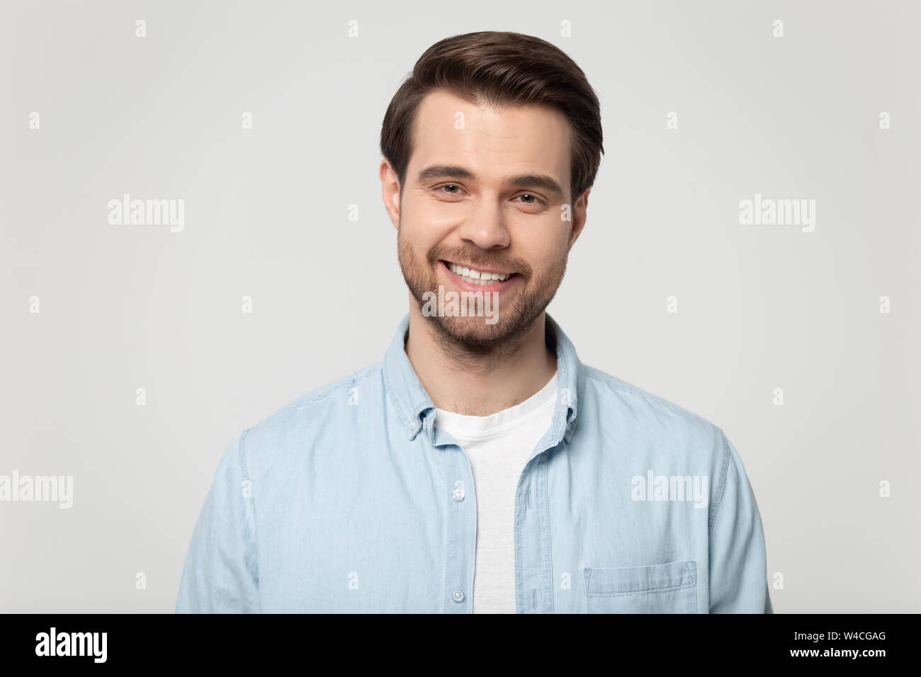Headshot portrait of smiling guy isolated on grey studio background ...