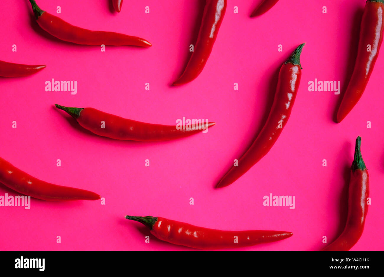 Fresh red cayenne peppers on neon pink vibrant background Stock Photo ...