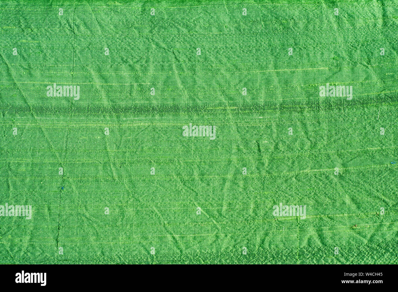 Texture of green shantung silk fabric closeup as textile background ...
