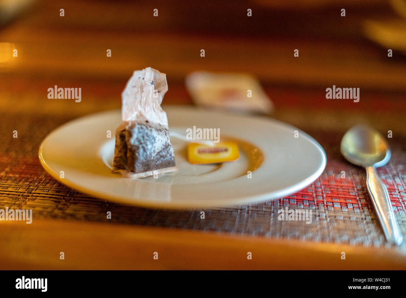 Used tea bag on an empty plate. diet concept Stock Photo - Alamy
