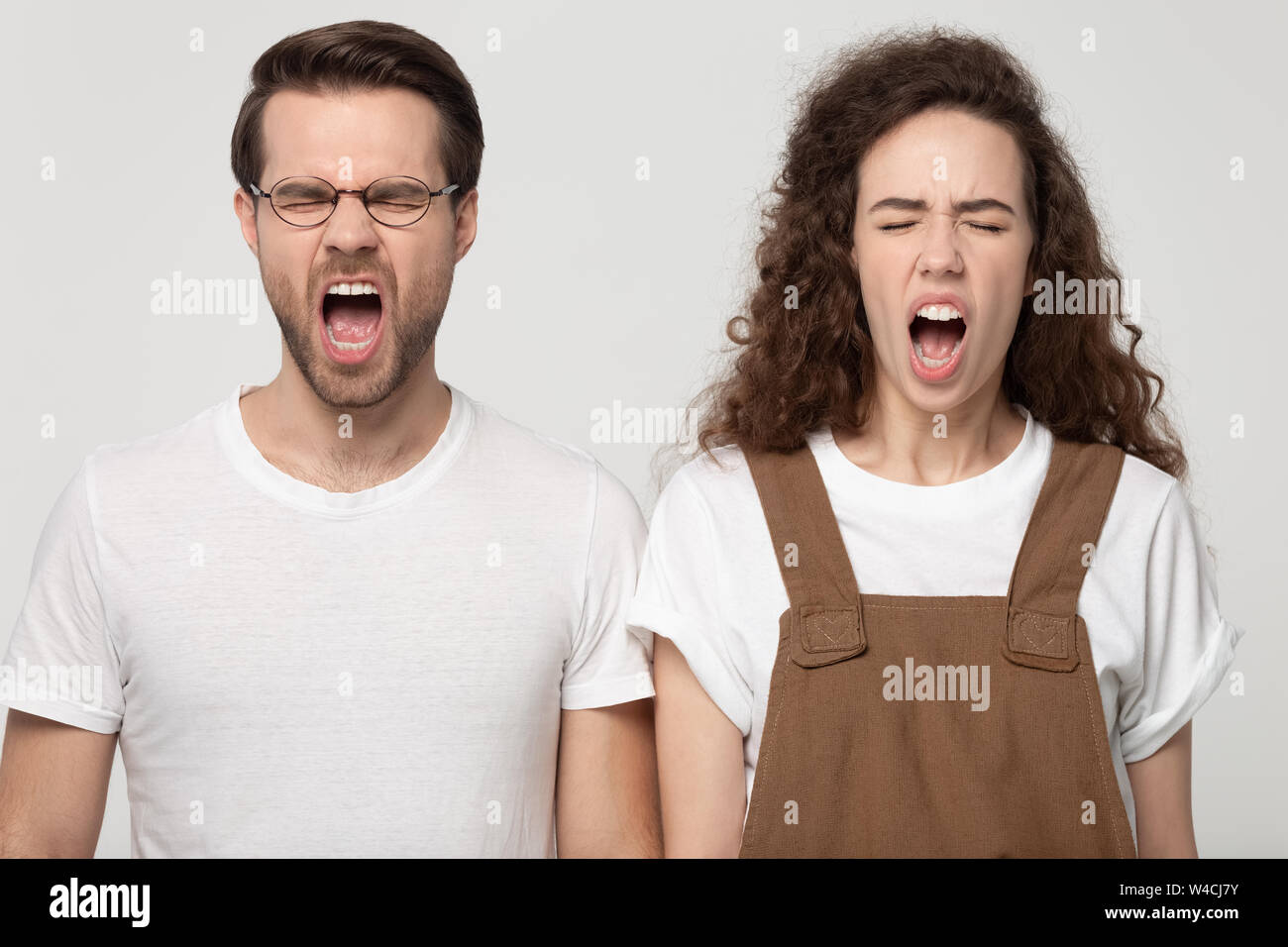 Couple screaming standing isolated on grey studio background Stock ...