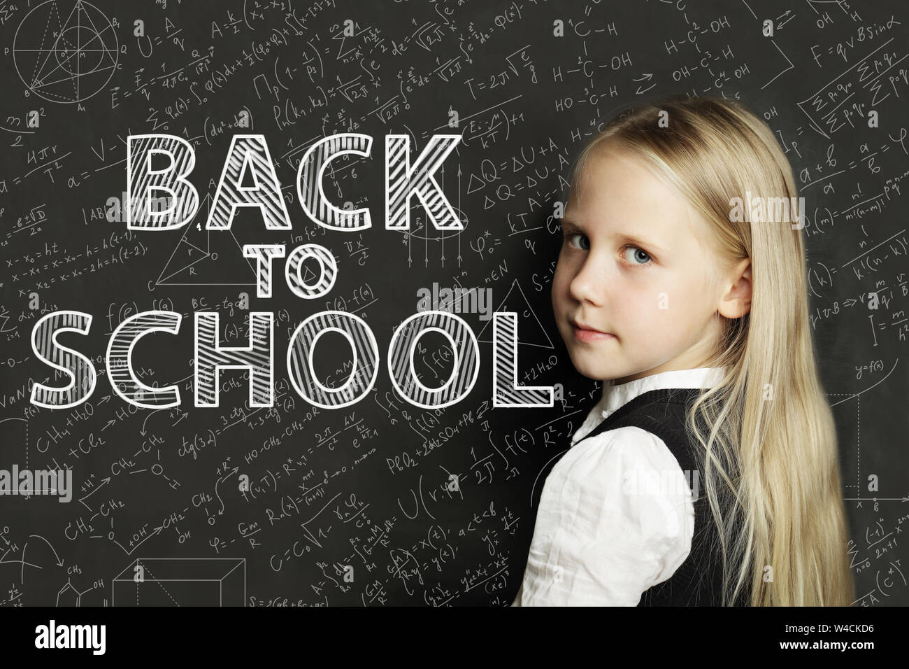 School girl and chalkboard with math formulas. Back to school ...