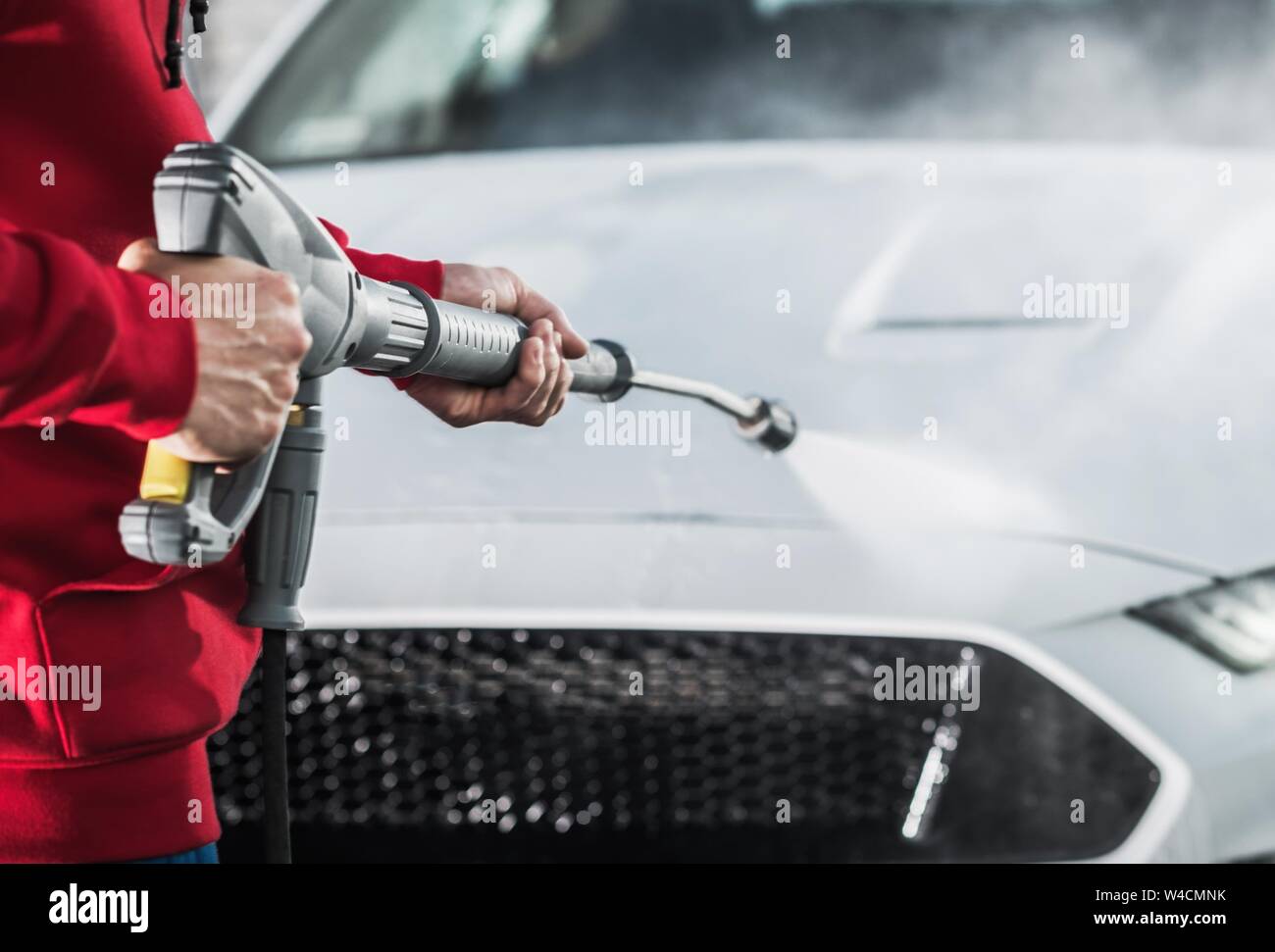 Car Washing Technology. Modern Pressure Washer in Action. Men Cleaning ...