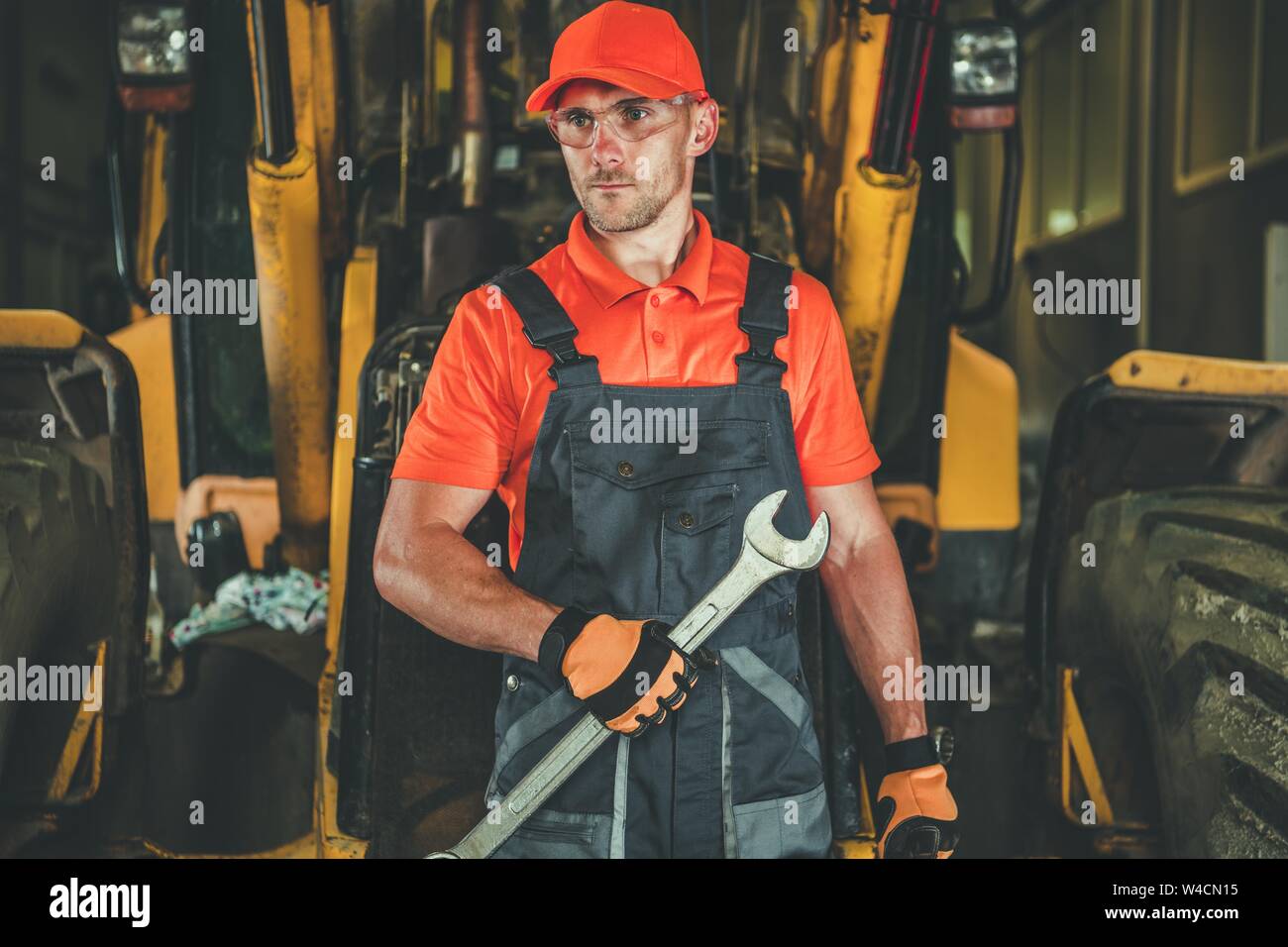 Heavy Equipment Fixing by Caucasian Professional Mechanic. Industrial ...