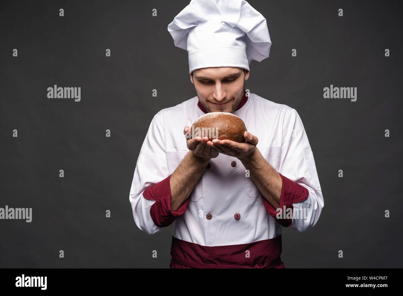 Male baker holding bread hi-res stock photography and images - Alamy