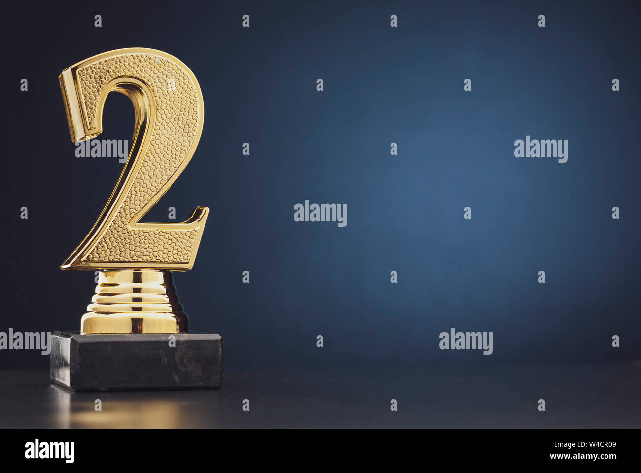 Second place winners gold trophy with a 3D textured metallic number two ...