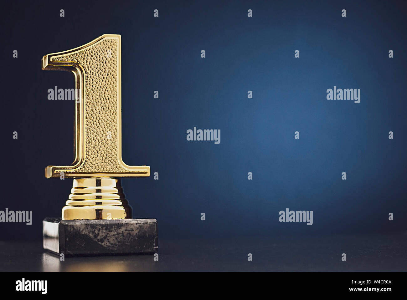 Champion or Winner gold trophy in the shape of a textured 3D number one ...