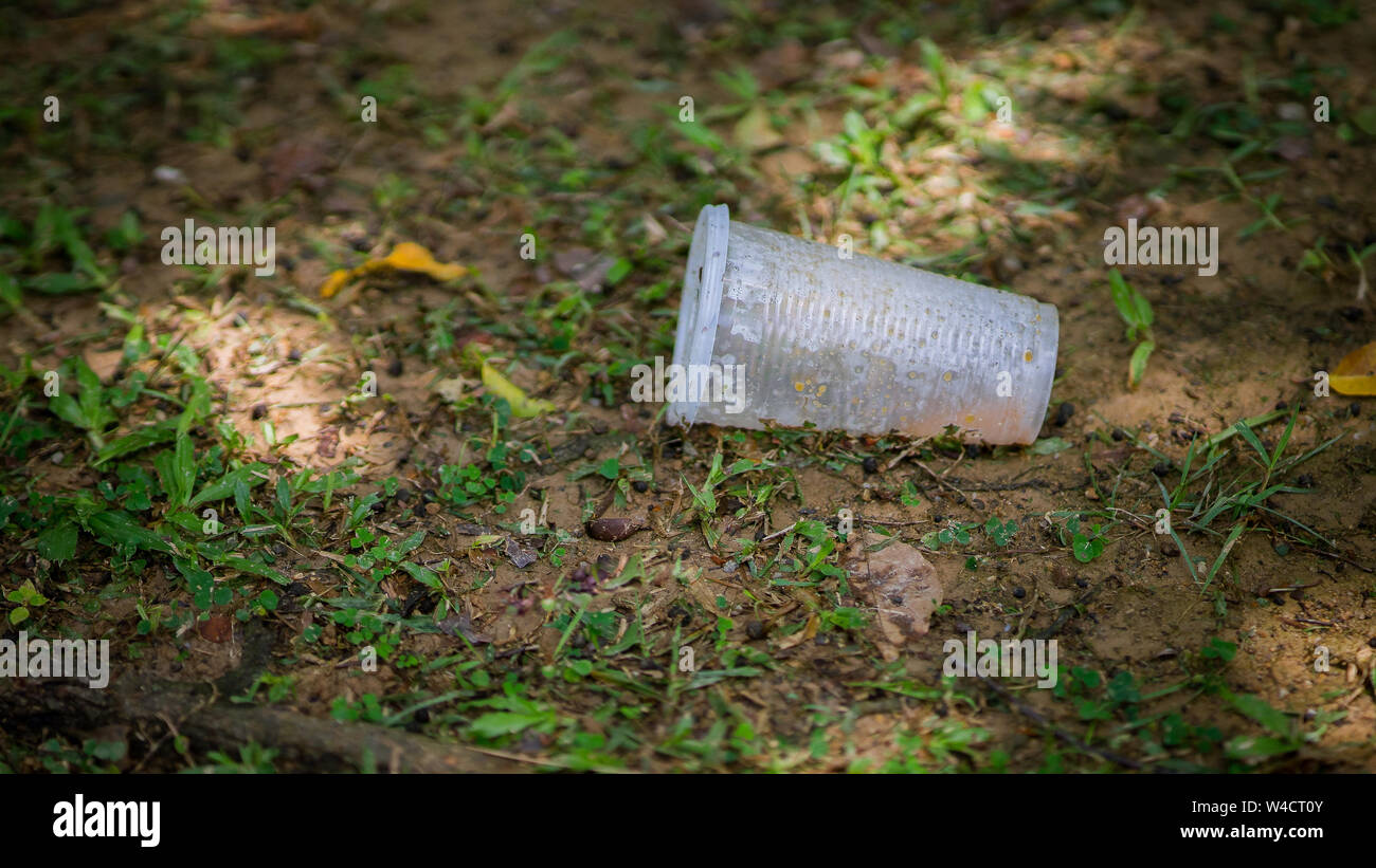 Plastic cup on the ground. Pollution of the environment. Garbage in the ...
