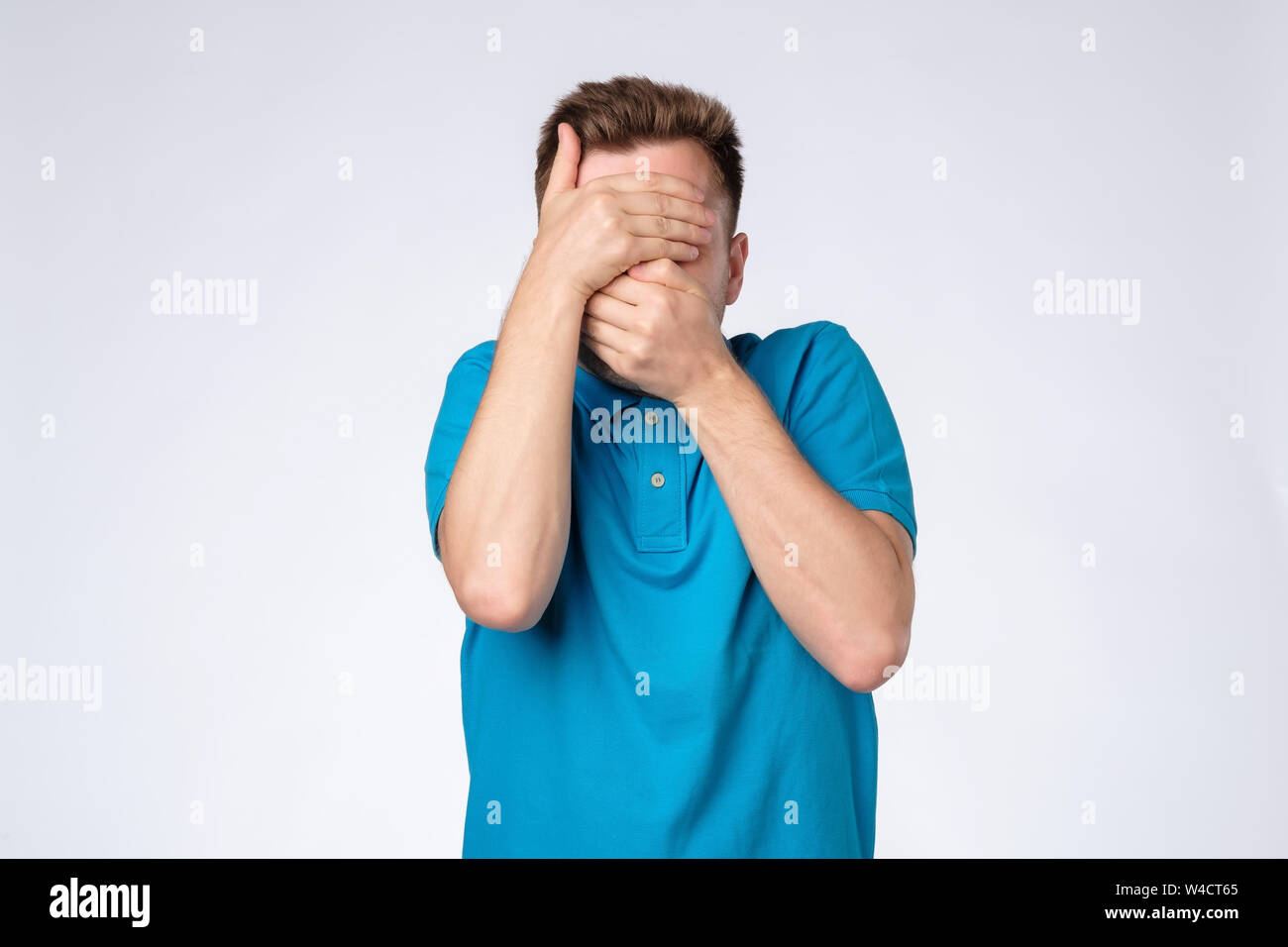 Person trying to hide face with hand hi-res stock photography and ...