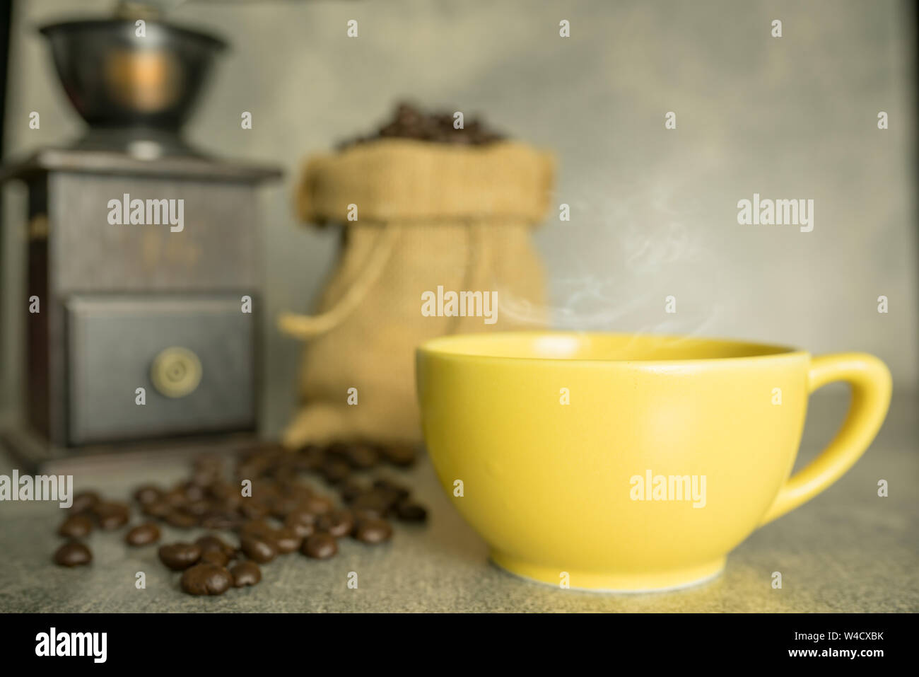 coffee beans in bag and yellow coffee cup Stock Photo - Alamy