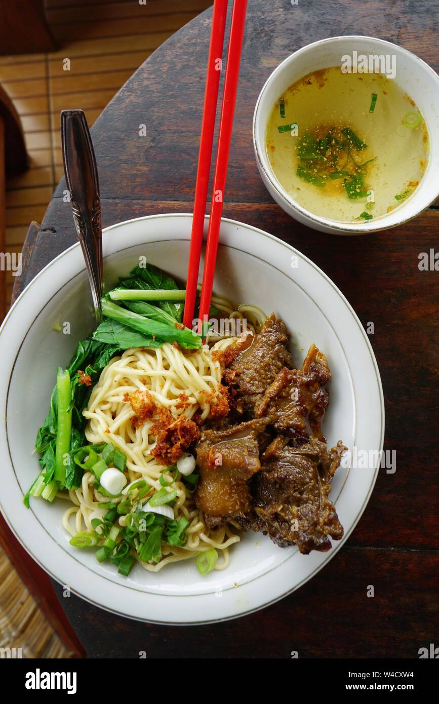 Noodles with Indonesian traditional sauce, chicken or duck sliced, and ...