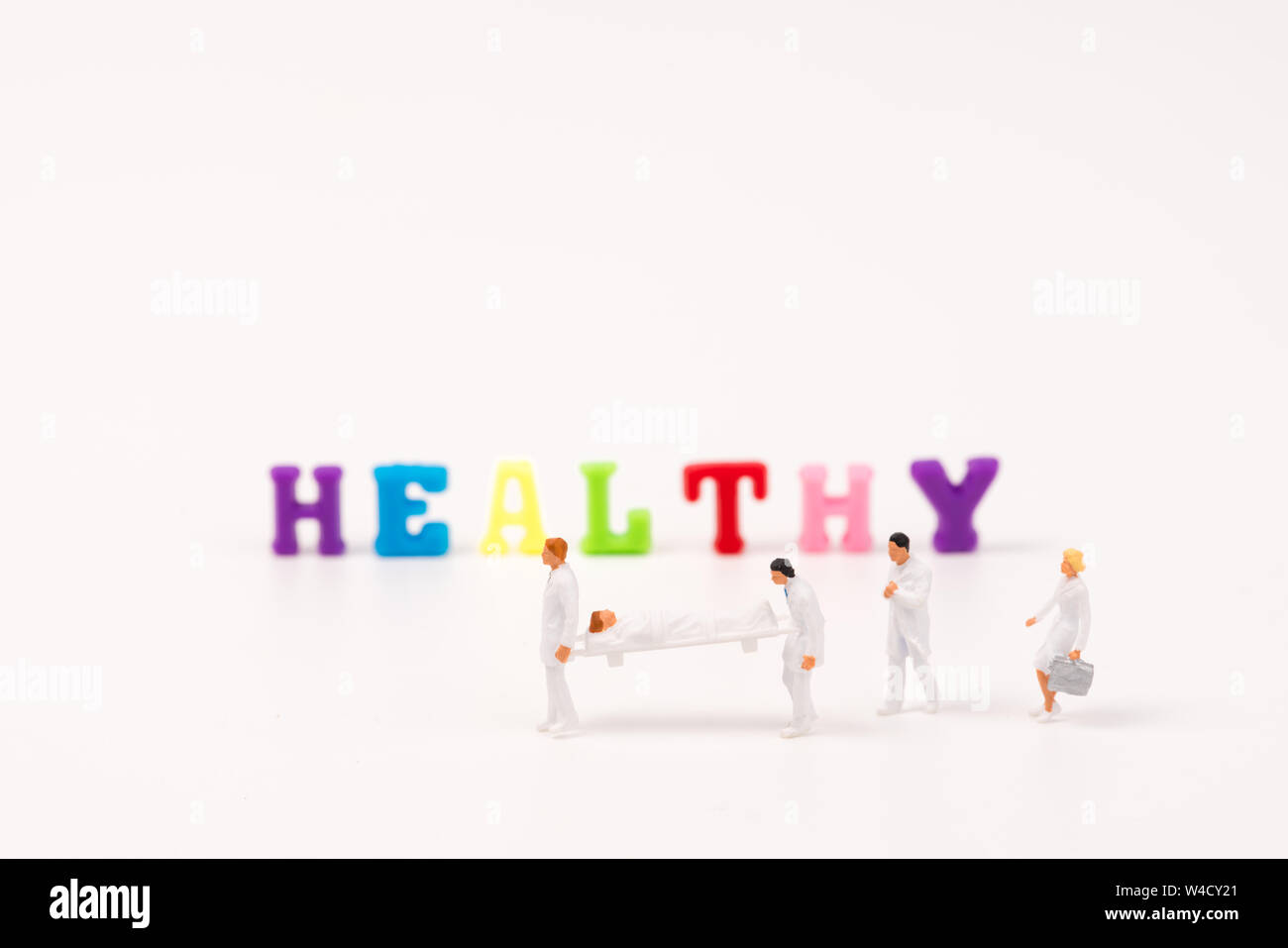 miniature peaple healthy teamwork help patient with HEALTHY text ...