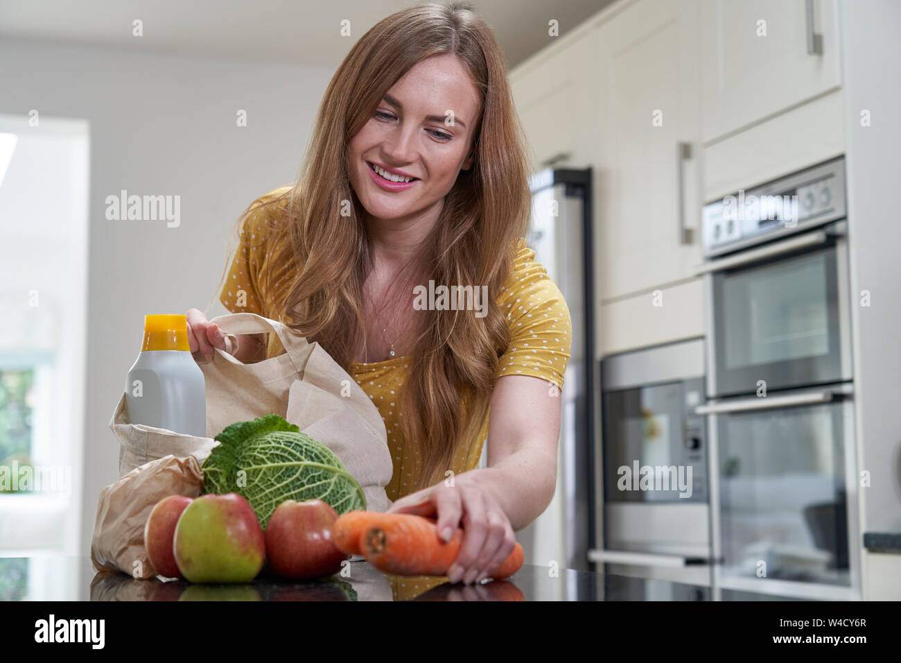Woman carrying plastic bag hi-res stock photography and images - Alamy