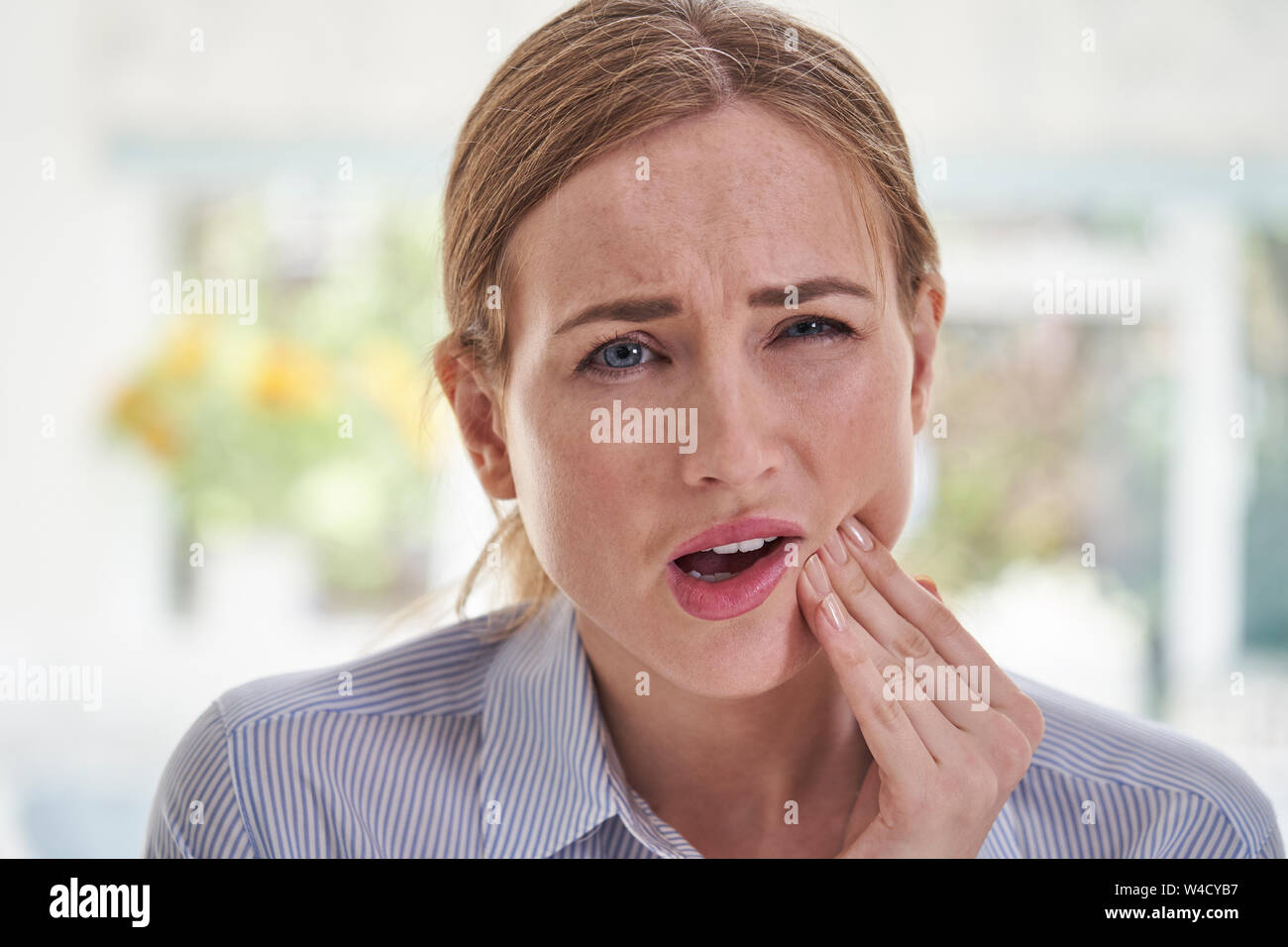 Portrait Of Young Woman Suffering With Toothache Touching Jaw Stock ...