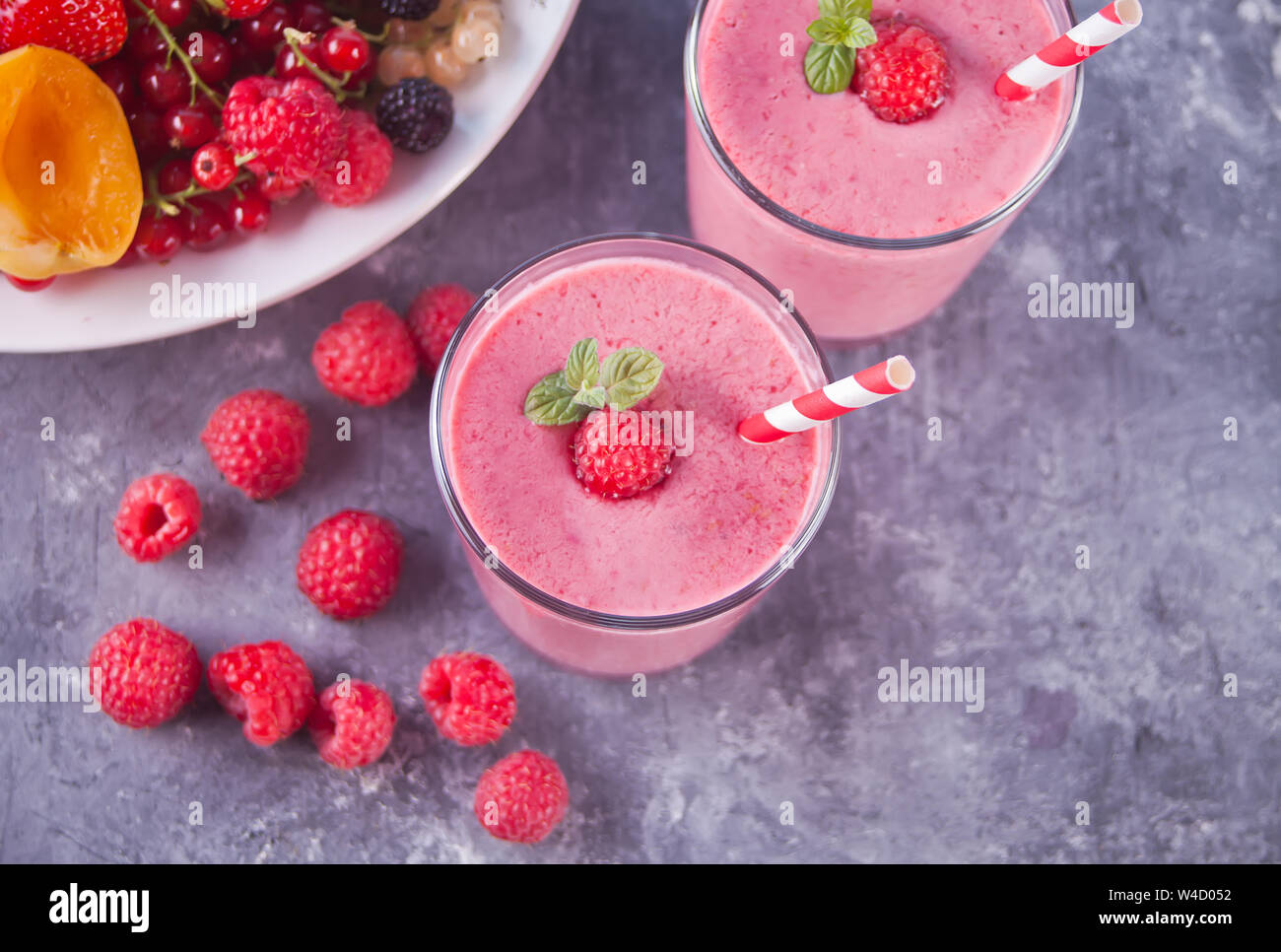 Raspberry smothies and raspberry fruit on the cocreate background. Top ...