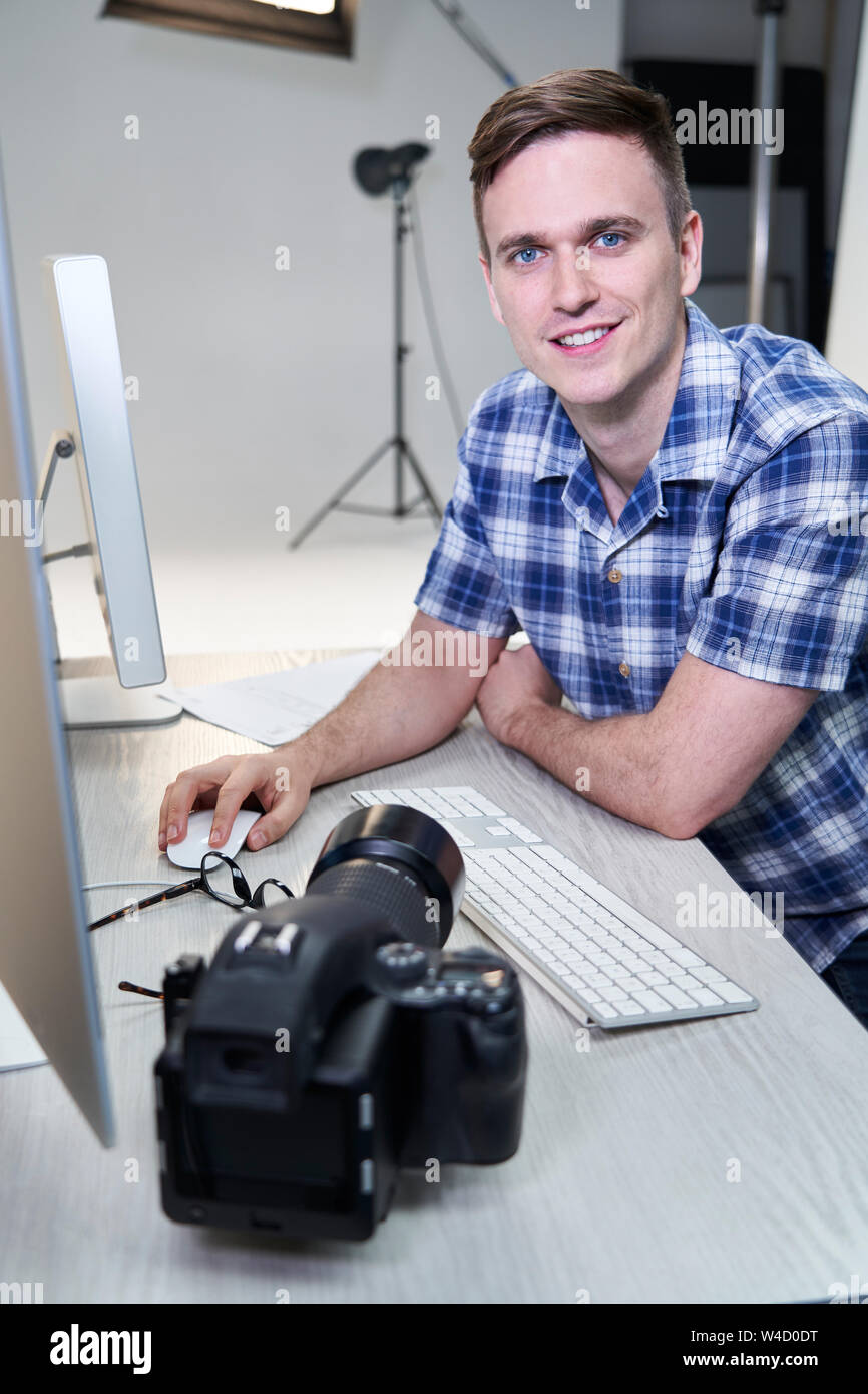 Portrait Of Male Photographer In Studio Reviewing Images From Photo ...