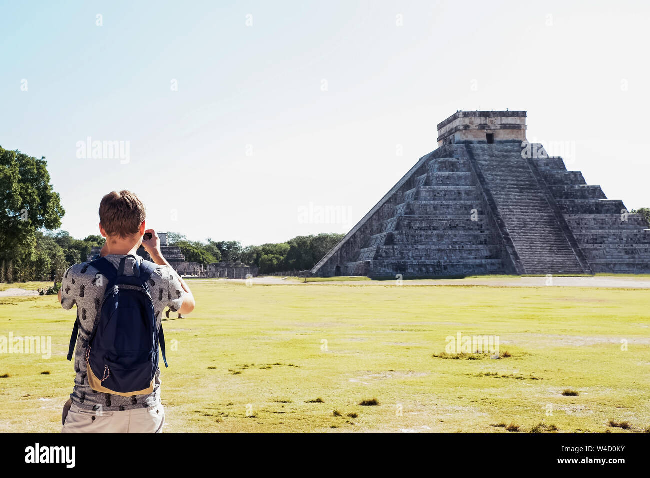 Man taking photo of ancient pyramid with his phone, Chichen Itza ...